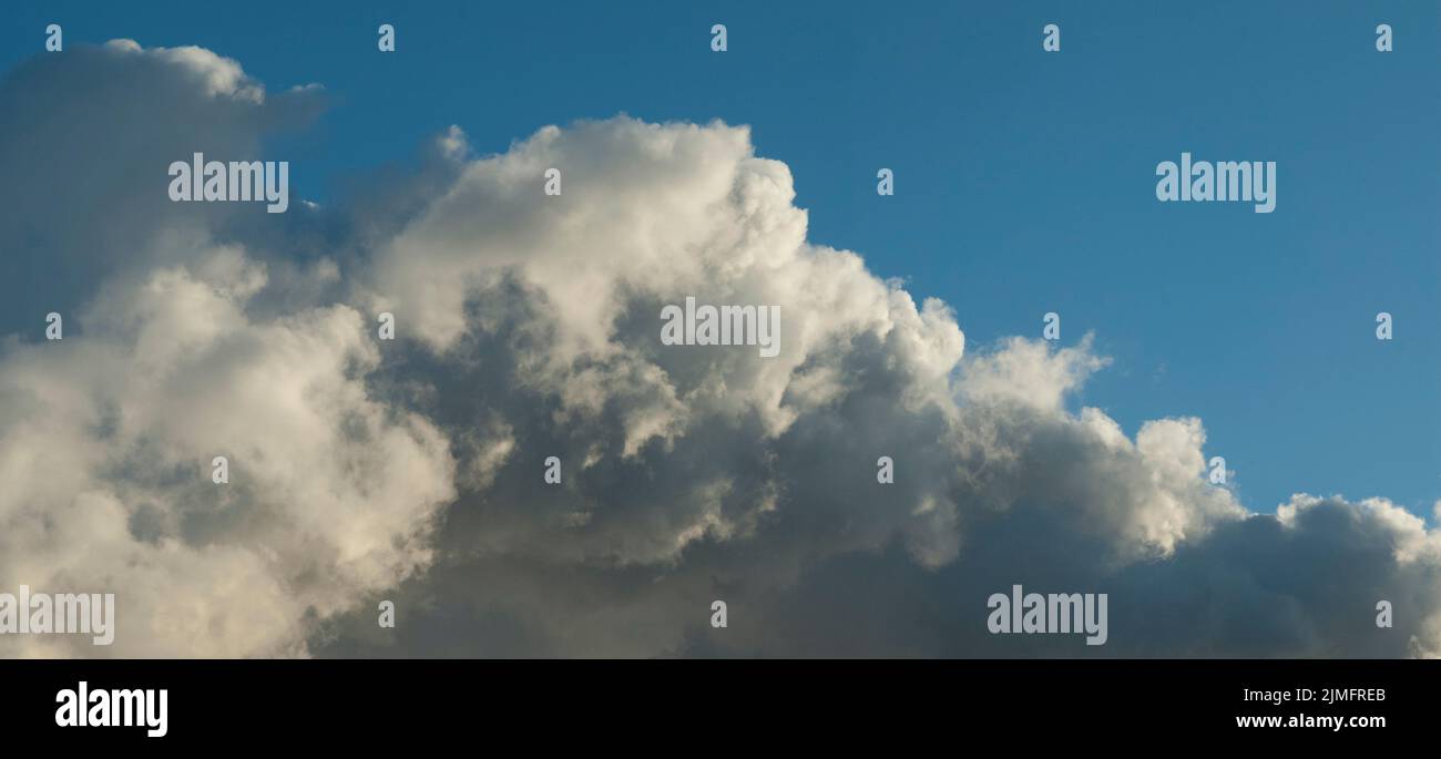Wave-like formation of clouds rolling in over a blue sky Stock Photo ...
