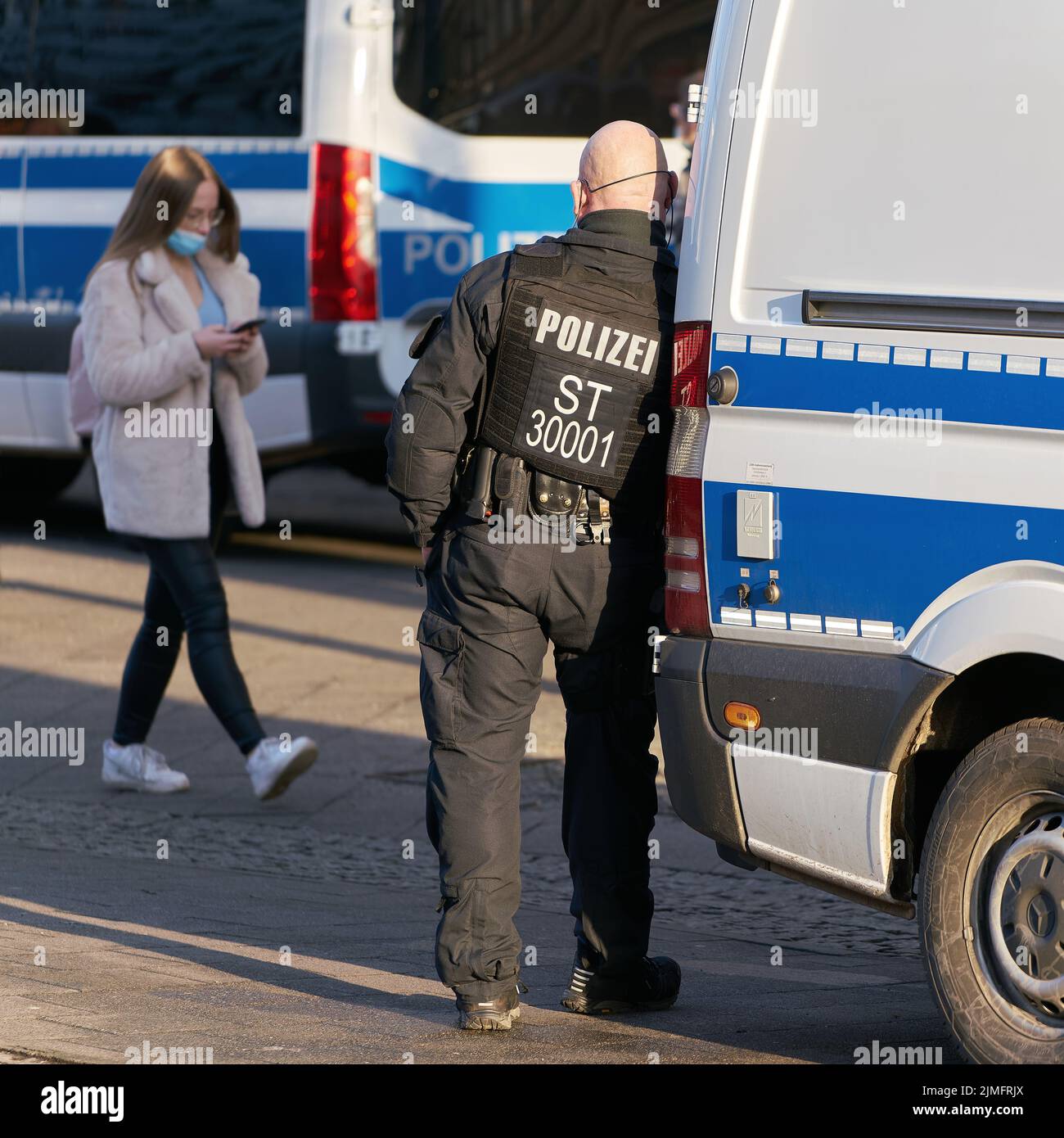 Police officer in downtown Magdeburg takes a break and is bored Stock ...