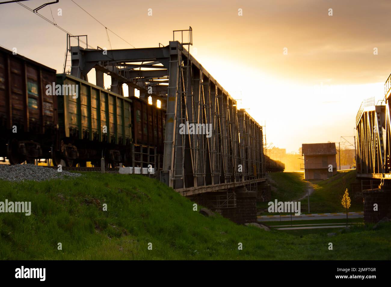 Selective focus. Freight cars on a railway bridge pulled by a train ...