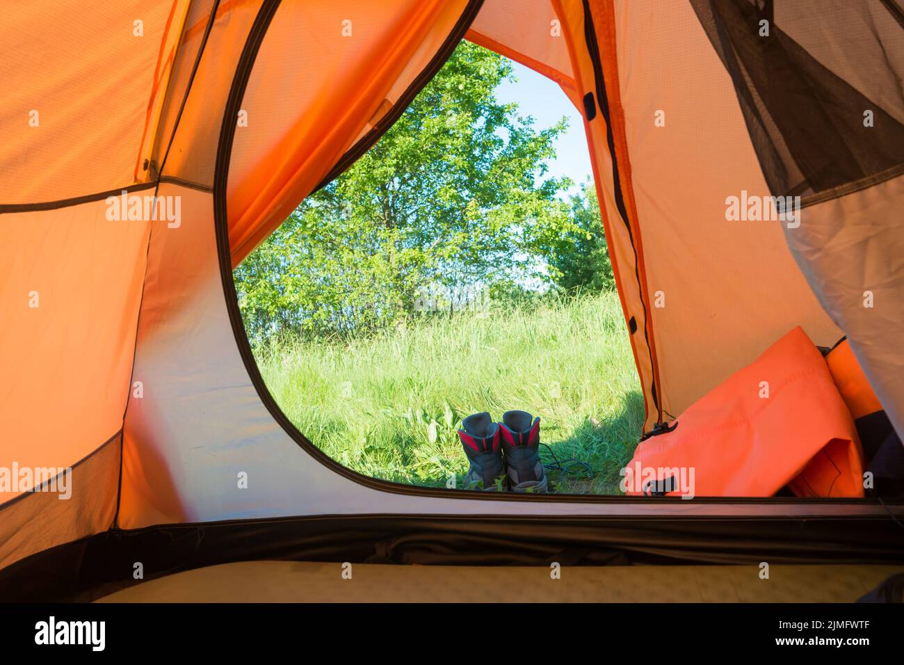 View from inside tent to green lawn Stock Photo - Alamy