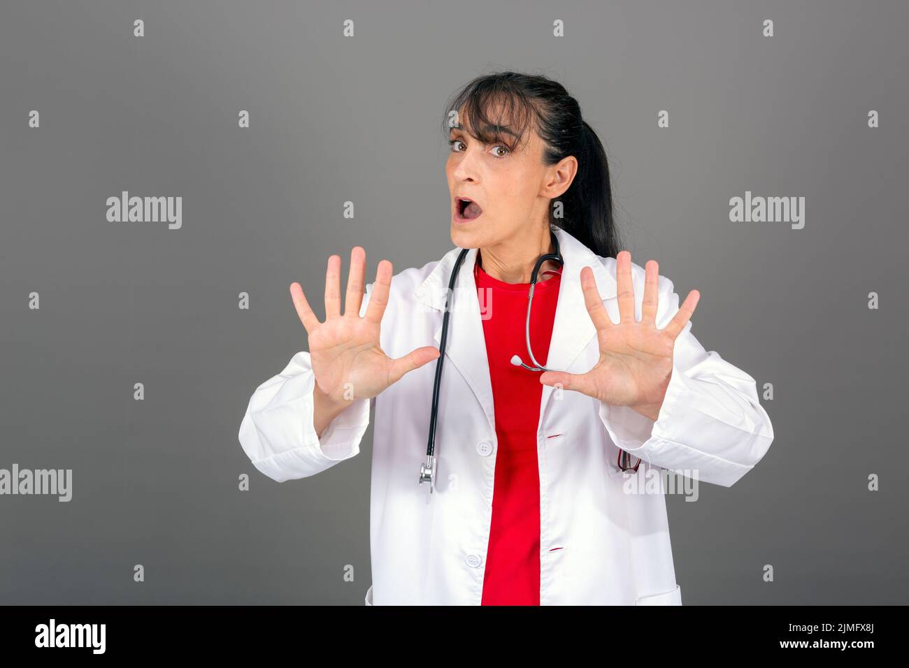 female doctor making a stop gesture with her palm. Warning expression ...