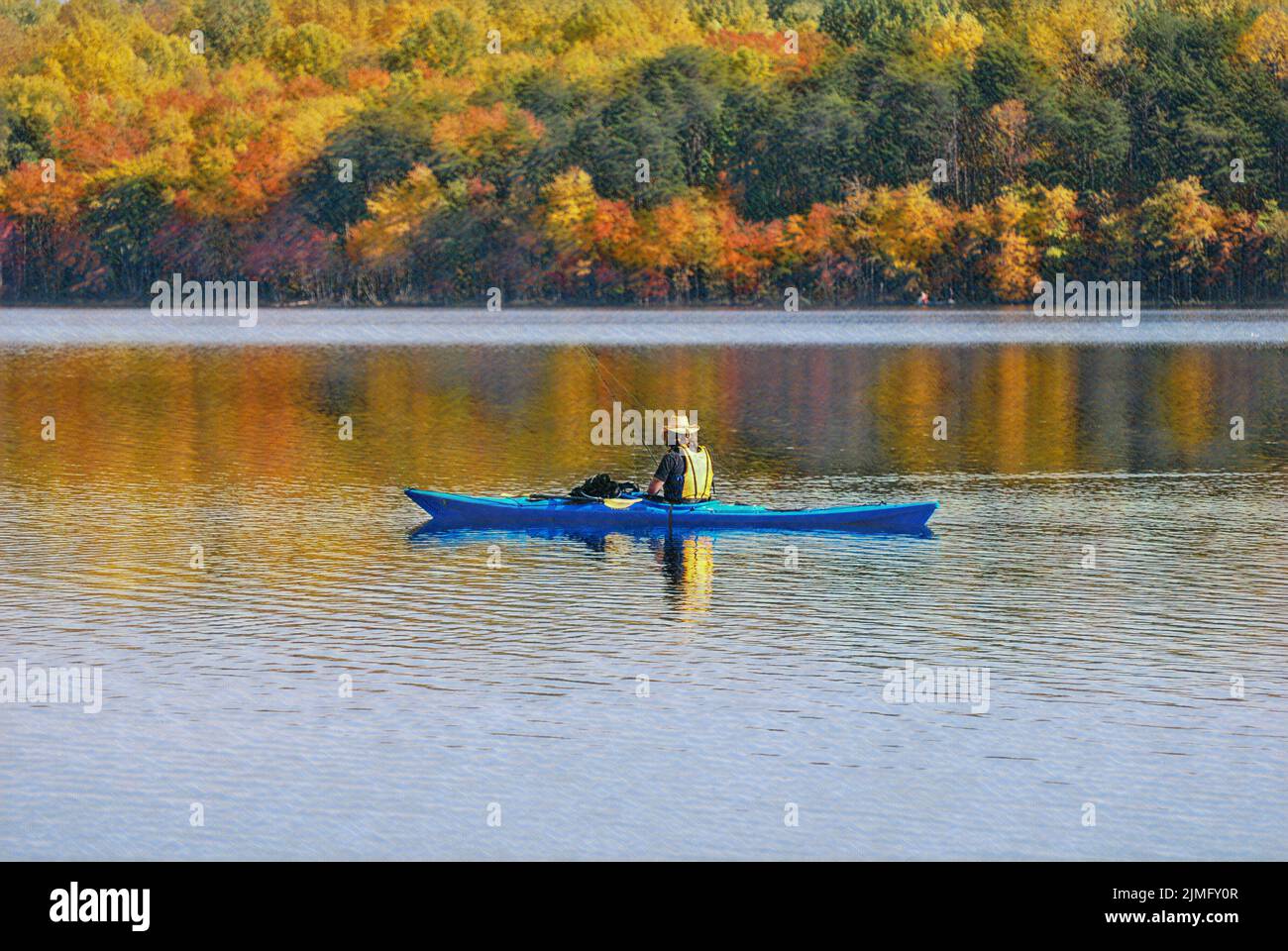 Kayaking Burke Lake in Virginia, with fall foliage. A person, a man ...