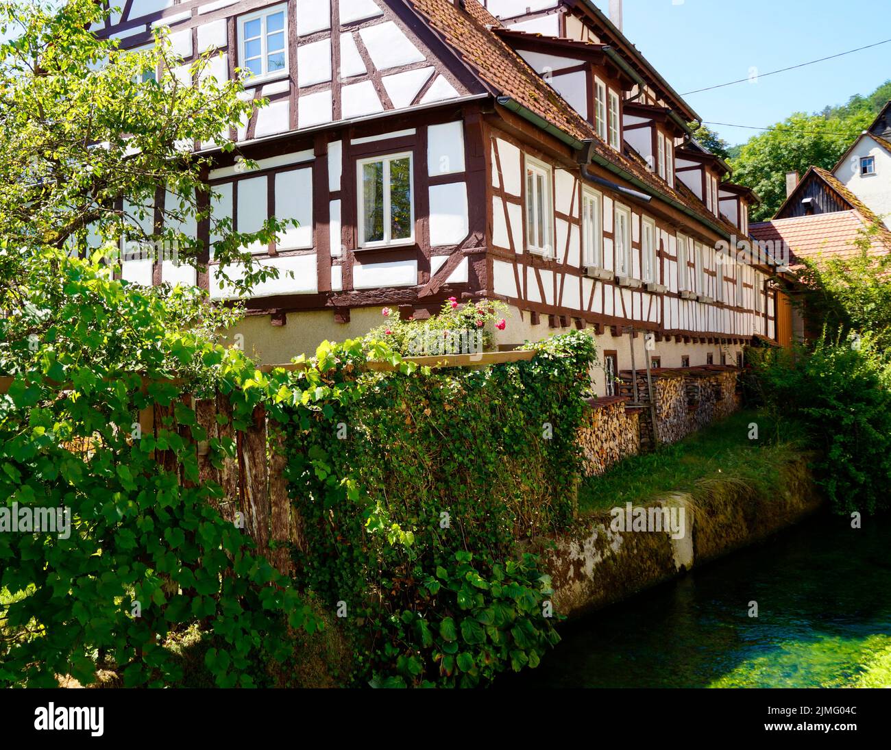 old timber-framed houses by the turquois pond called Blautopf (Blue Pot ...