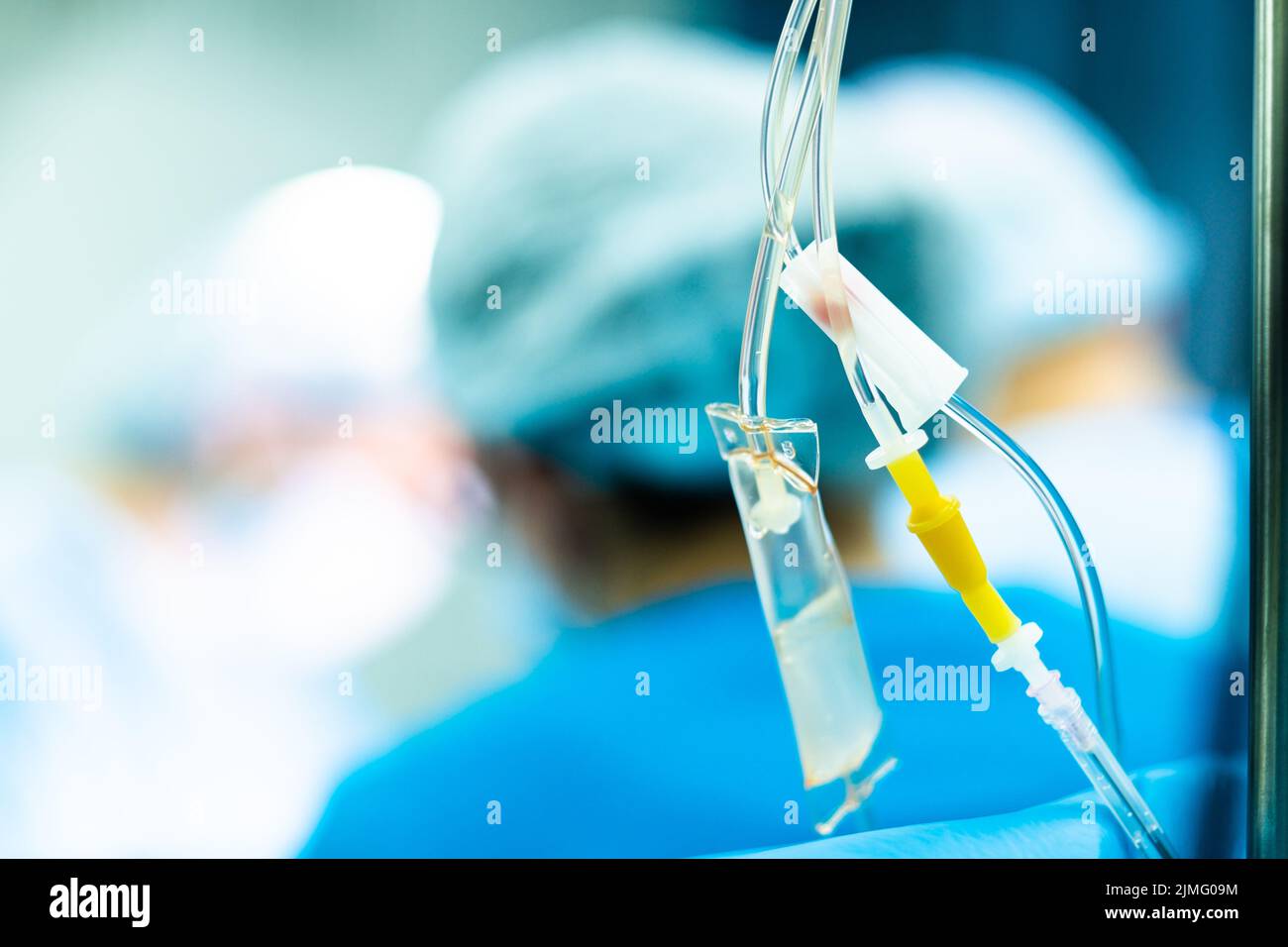 Transparent tubes of a medical dropper with saline on a blurred ...
