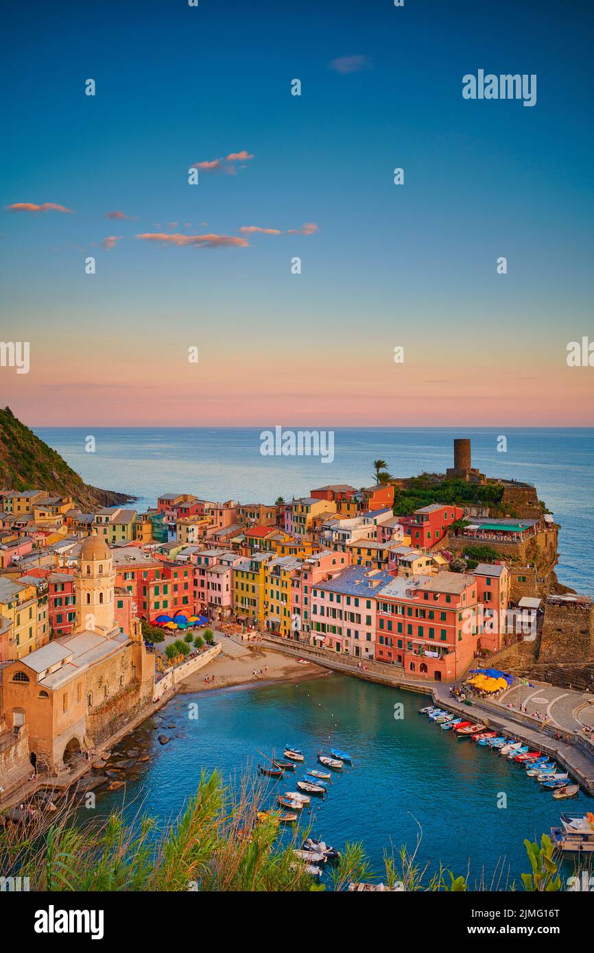 A vertical drone shot of a small shoreside village with colorful ...