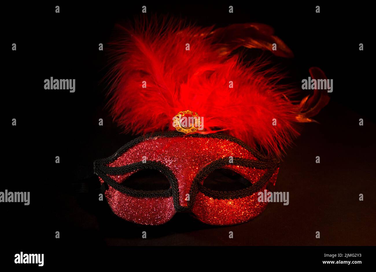 Carnival symbol mask in golden red color with feathers Stock Photo - Alamy