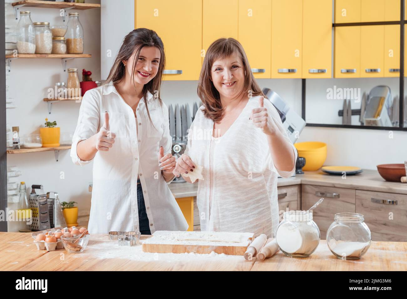 women baking fun pastry thumbs up hobby Stock Photo - Alamy