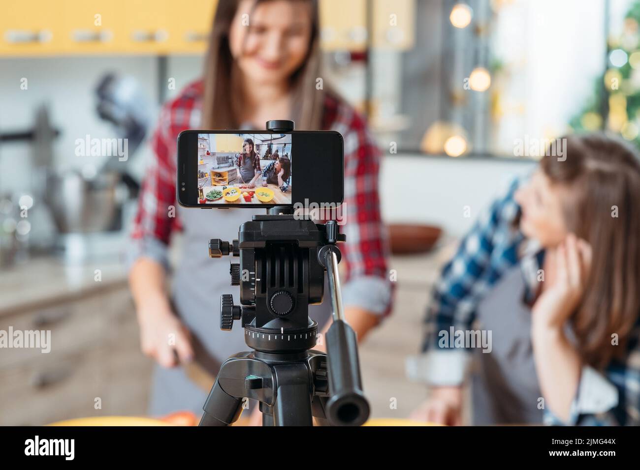 cooking blog two women shooting video smartphone Stock Photo - Alamy