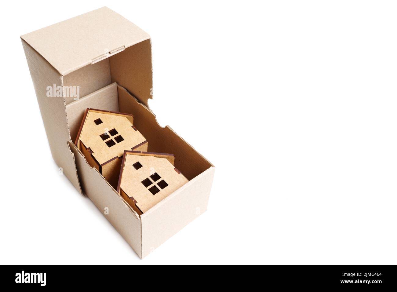 Two wooden toy houses inside a small shipping box. Creative moving in ...