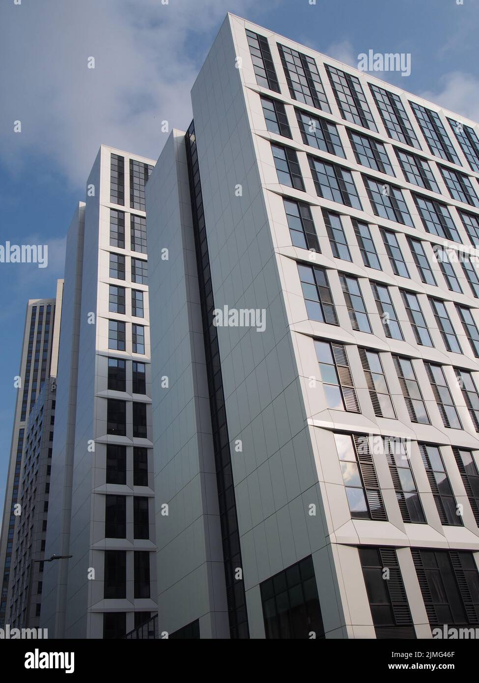 Close up perspective detail of a row of tall high rise modern apartment ...