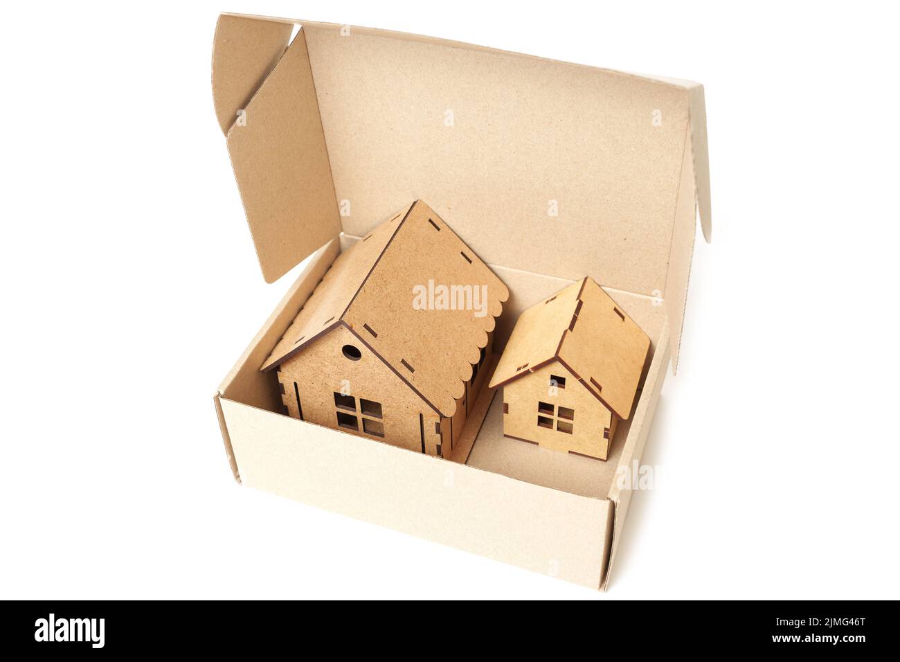 Small cardboard box with two toy houses inside. House trade in program ...