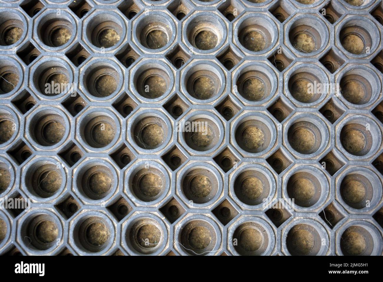 Unusual rubber gray rug consisting of unusual, deep textured holes ...