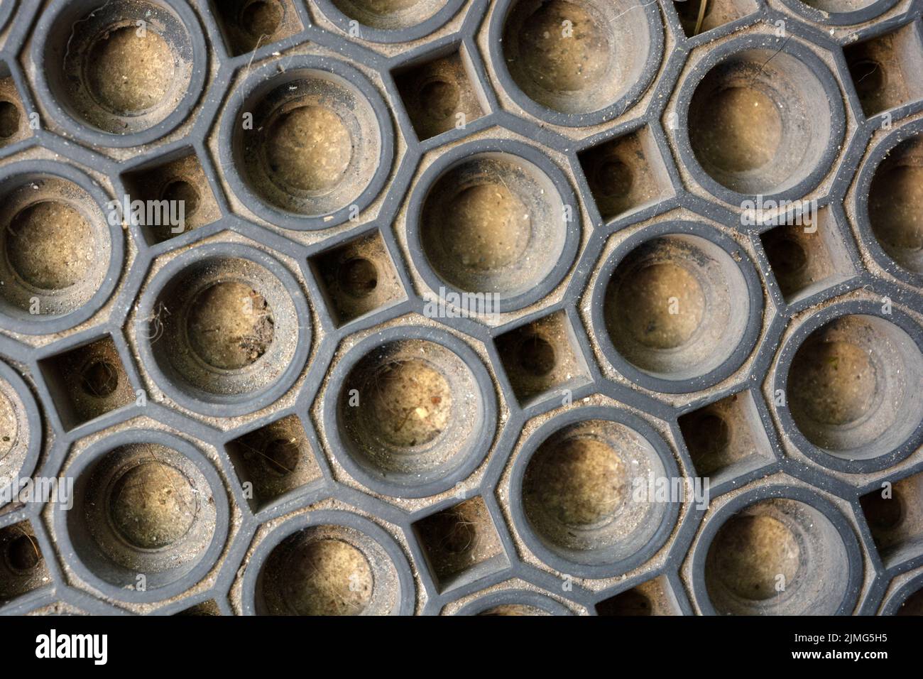 Unusual rubber gray rug consisting of unusual, deep textured holes ...