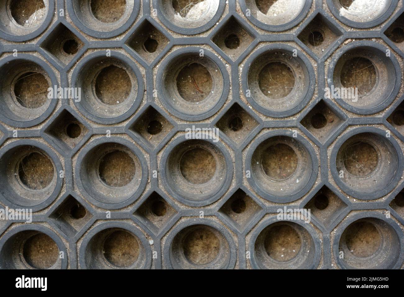 Unusual rubber gray rug consisting of unusual, deep textured holes ...