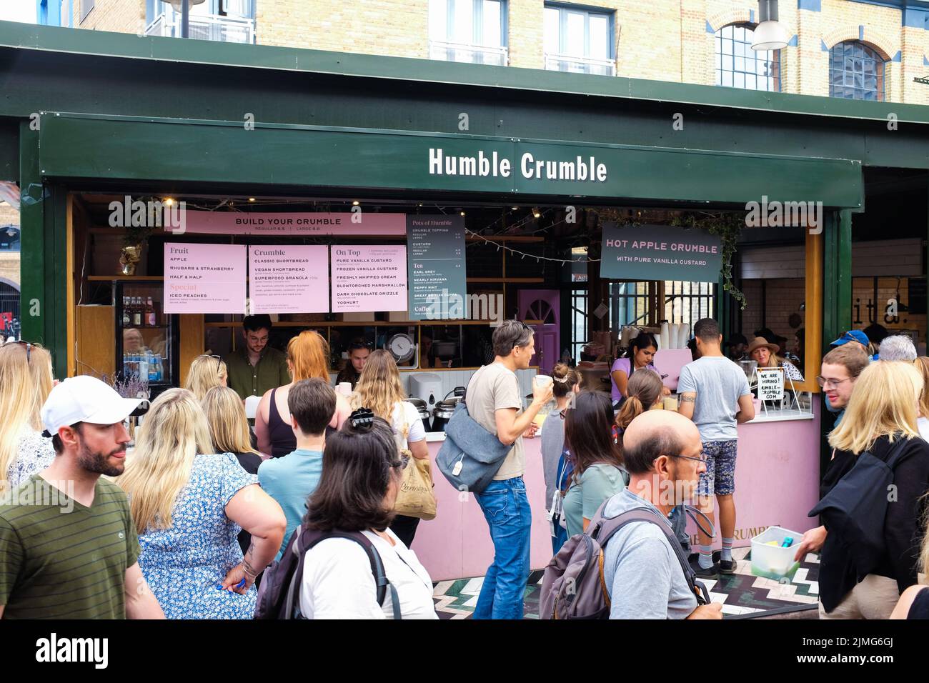 A shop at London's Borough Market selling fruit crumble with a variety ...