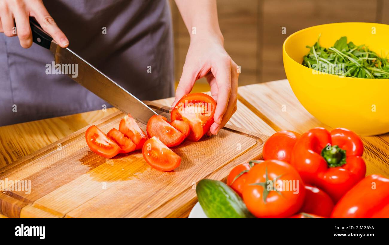 vegetarian lifestyle cooking chopping tomatoes Stock Photo - Alamy