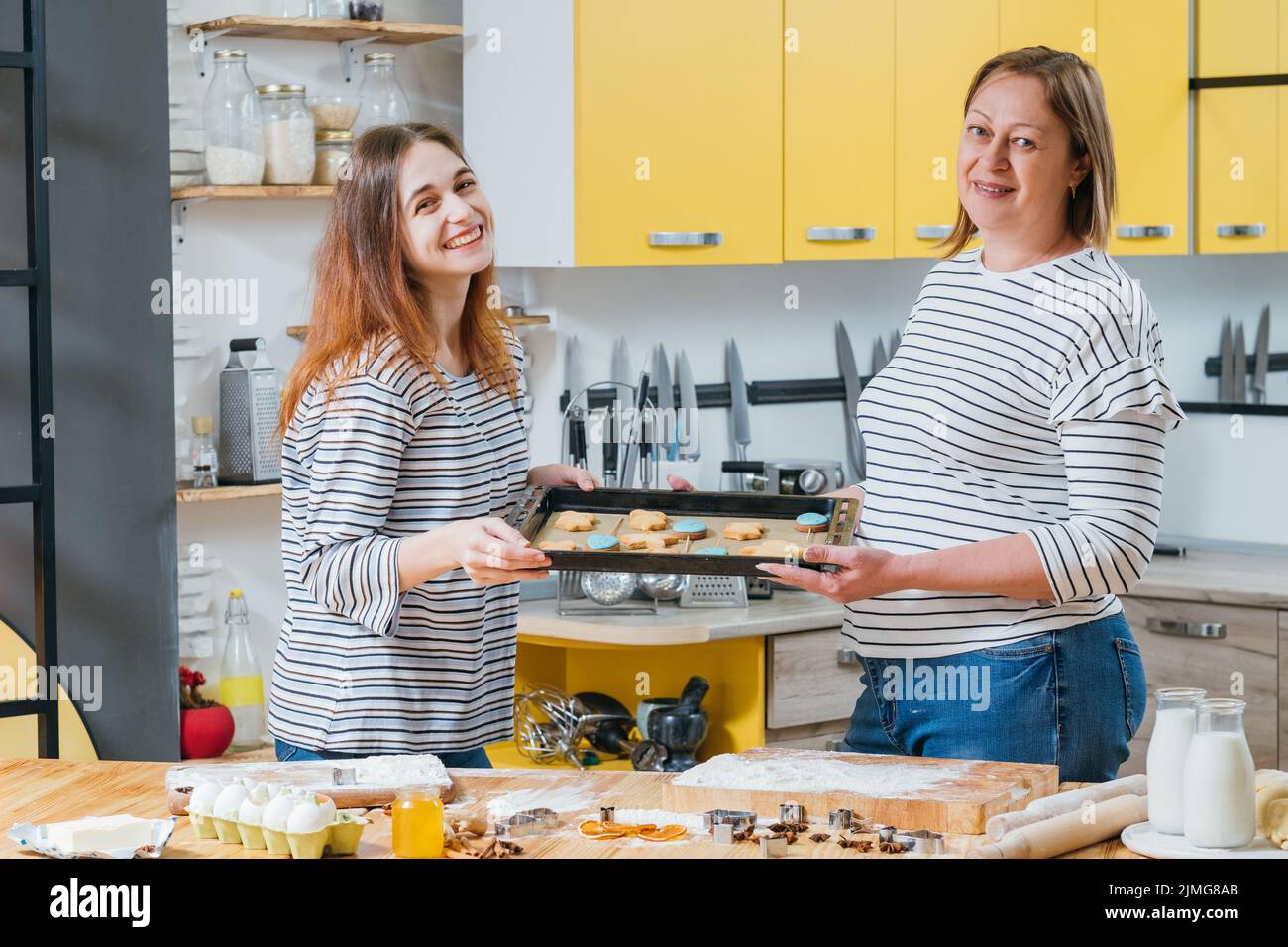 family leisure mother daughter sheet pan biscuits Stock Photo - Alamy