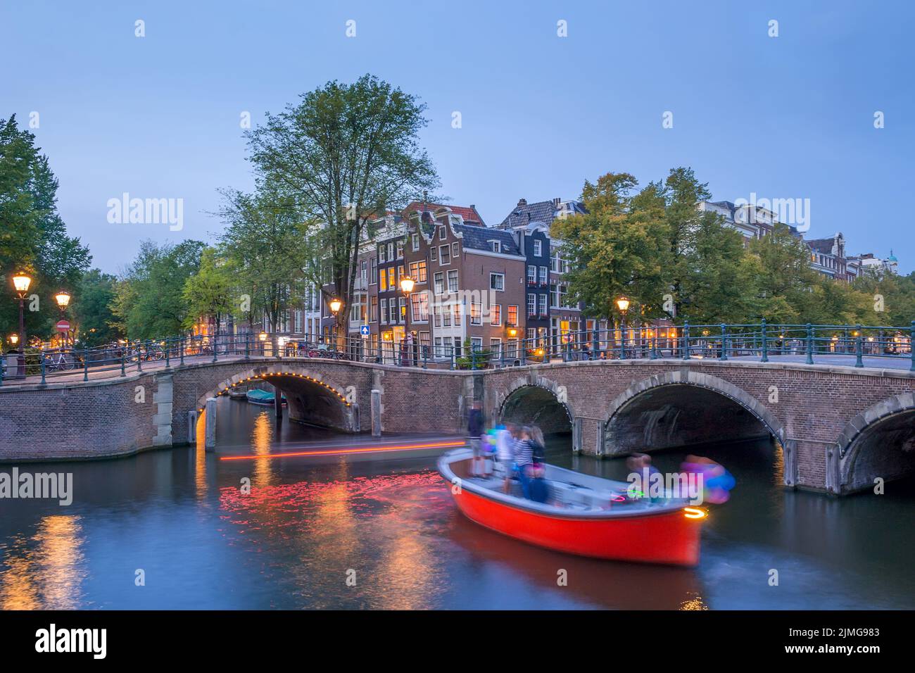 Spring Evening on the Amsterdam Canal and Pleasure Boat Stock Photo - Alamy