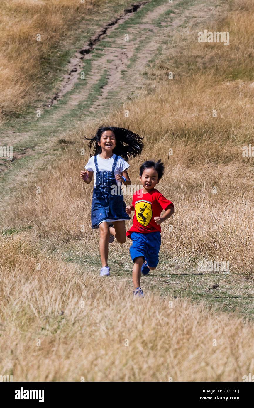 Children running down hill hi-res stock photography and images - Alamy