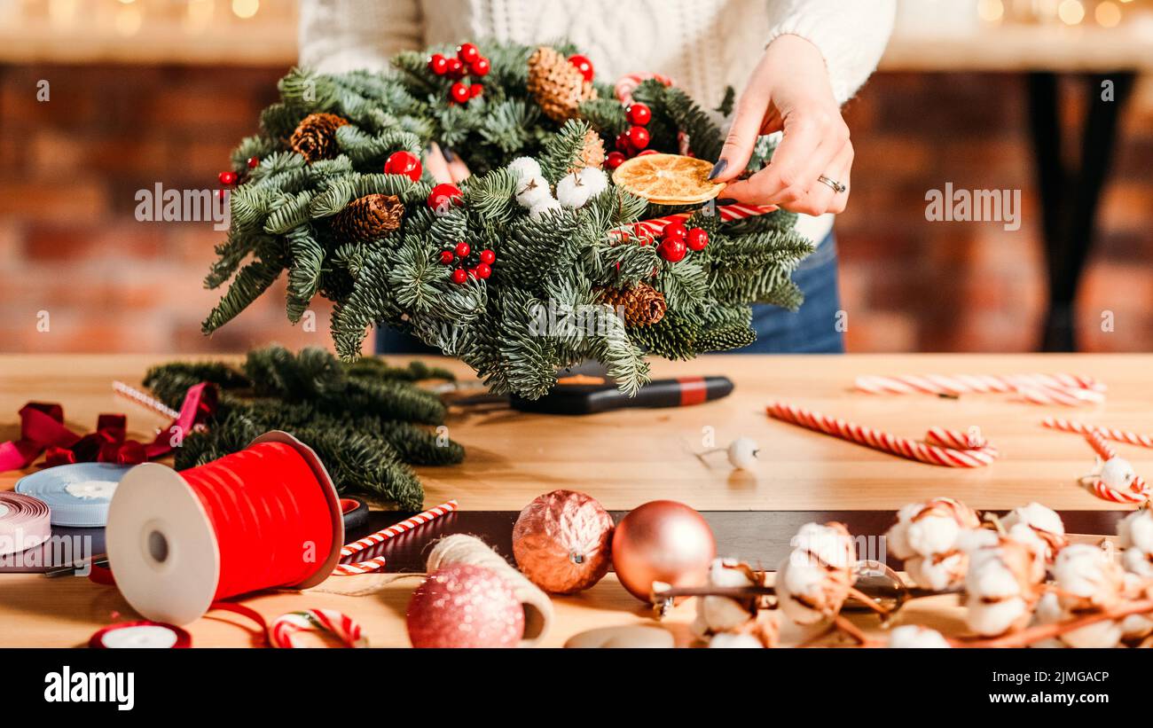 florist craft studio lady green fir tree wreath Stock Photo - Alamy