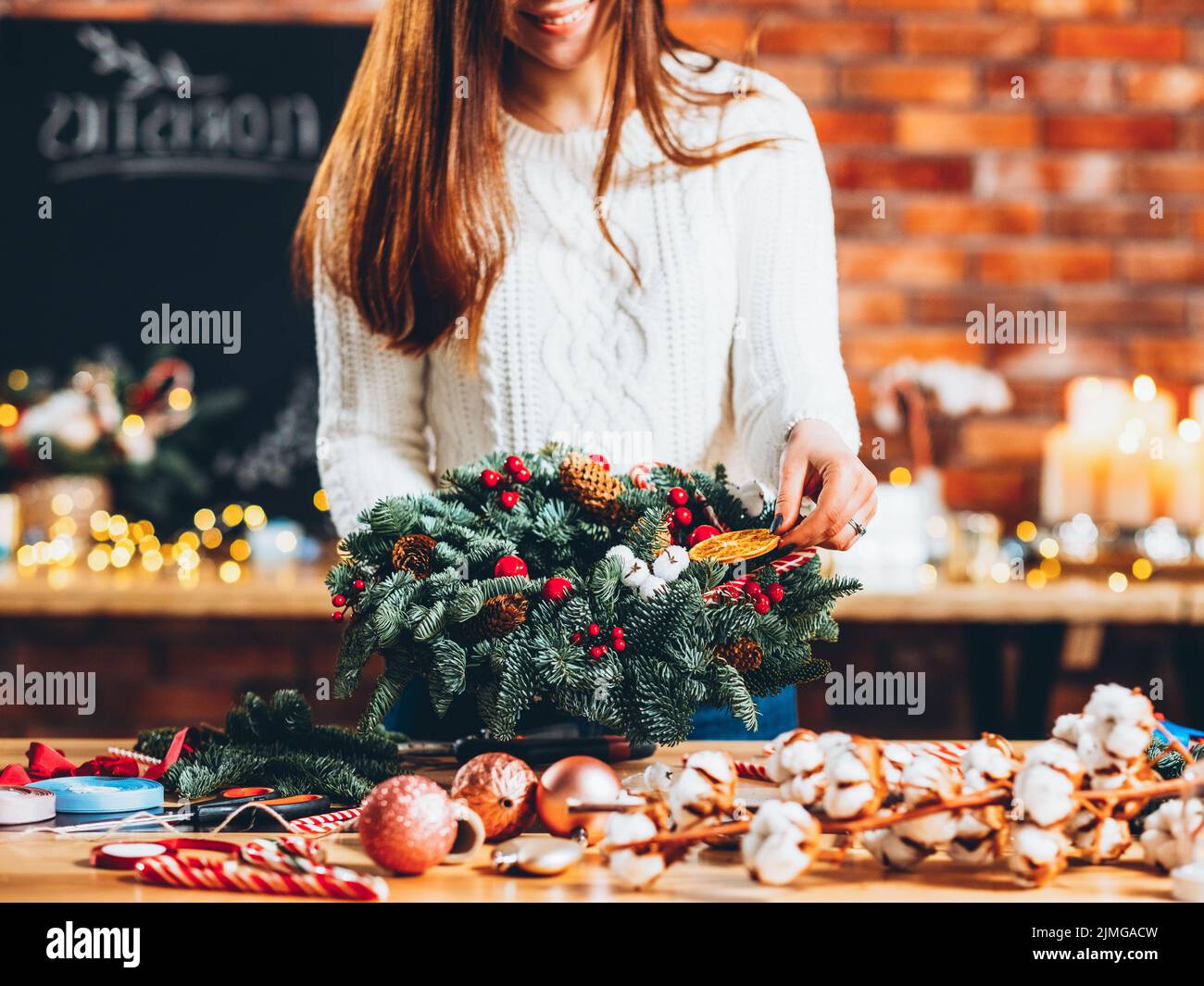 florist creative business lady fir tree wreath Stock Photo - Alamy