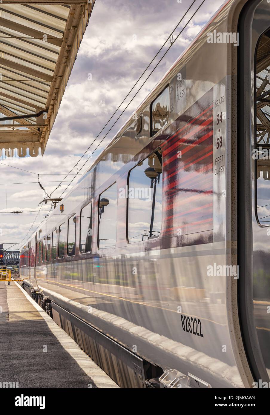 A railway carriage rests beside a platform while preparing to depart. A ...