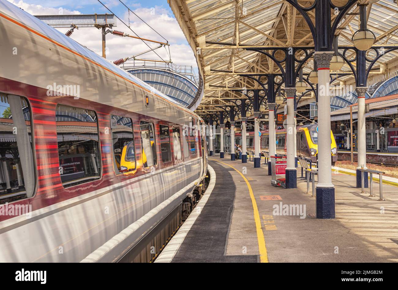 A railway carriage rests beside a platform while preparing to depart. A ...