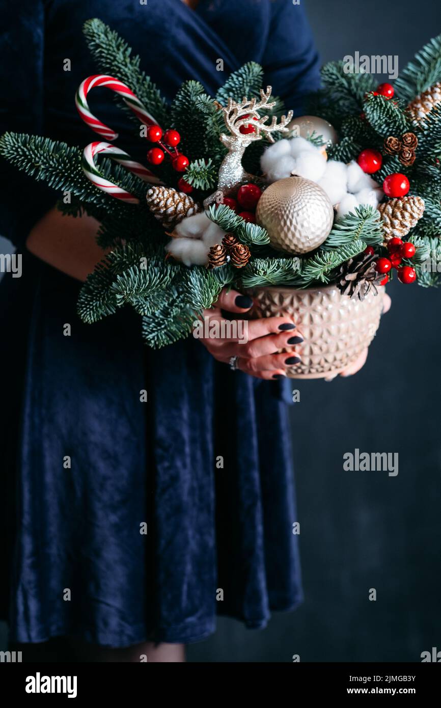 florist workshop lady pot fir tree candy canes Stock Photo - Alamy