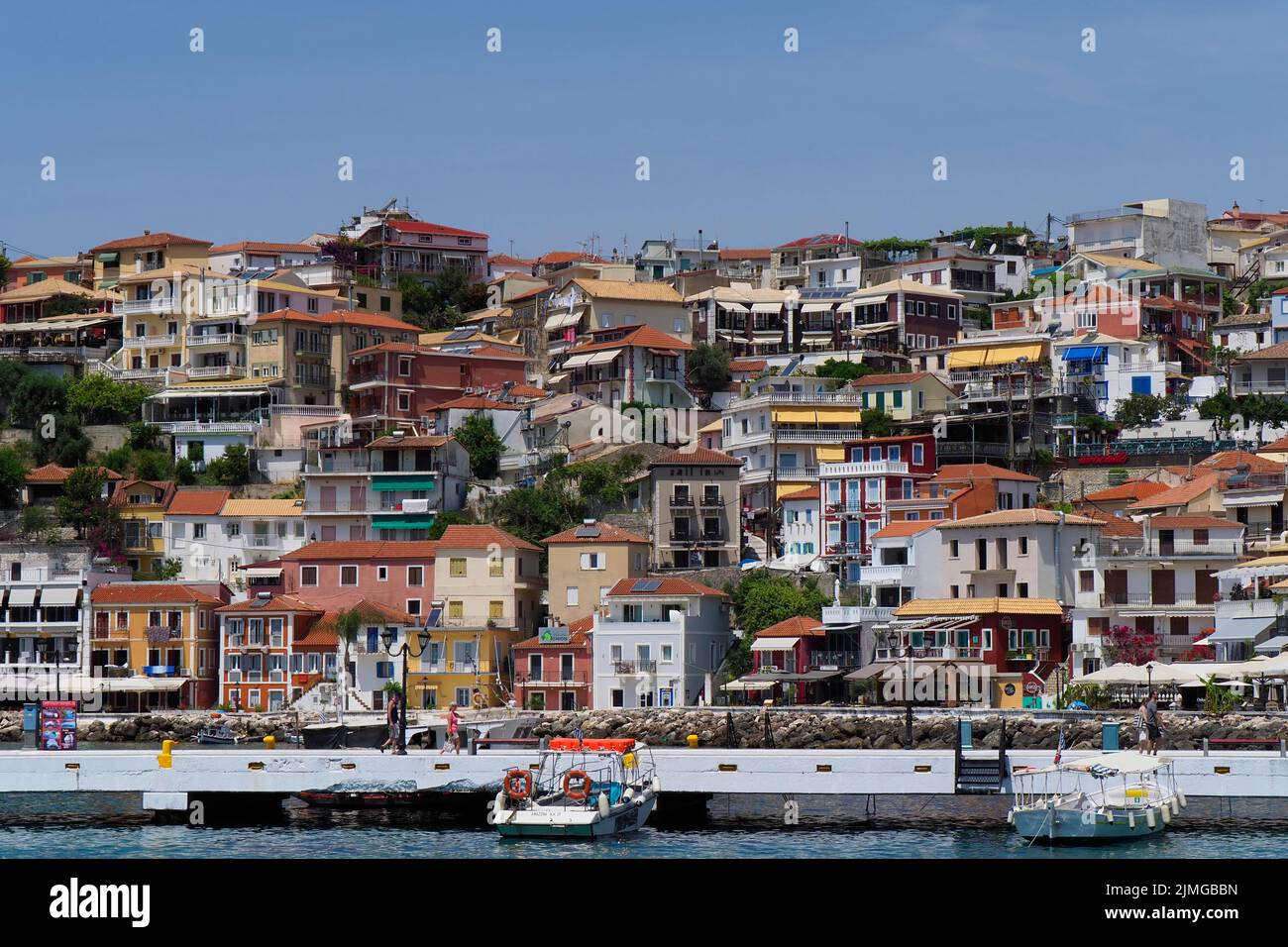 colourful houses on the hillside above the seafront at Parga,Greece ...
