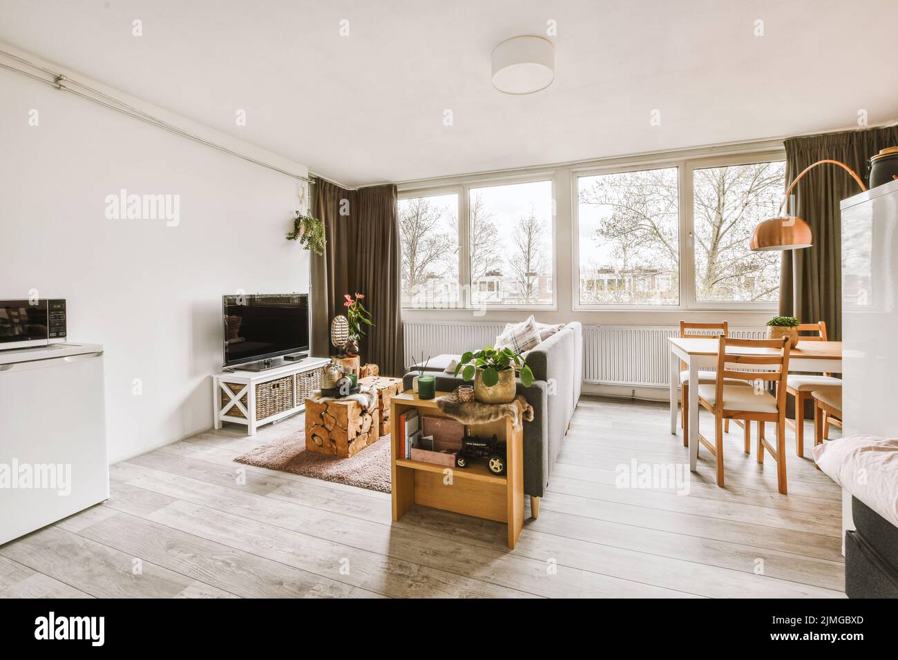 Table with chairs and flowers located near lounge area and kitchen in ...