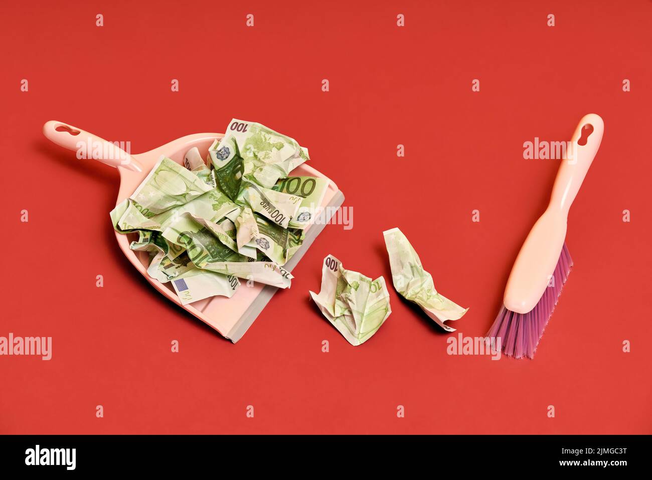 Creative layout with dustpan, hand brooms and crumpled money dollar ...