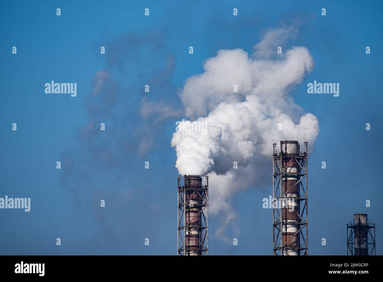 Smoke stack of coal power plant on blue sky background Stock Photo - Alamy