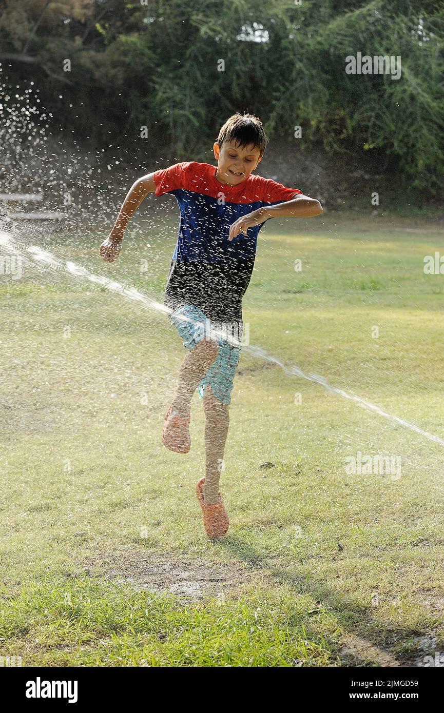 Child play water jets hi-res stock photography and images - Alamy