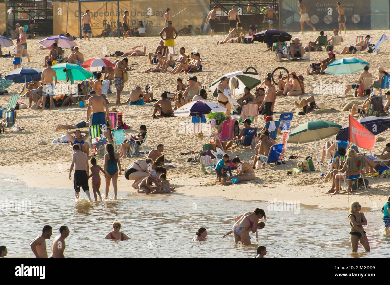 Montevideo, Uruguay - 11th January 2022 - Beautiful sunset on Pocitos beach with bathers on a ...