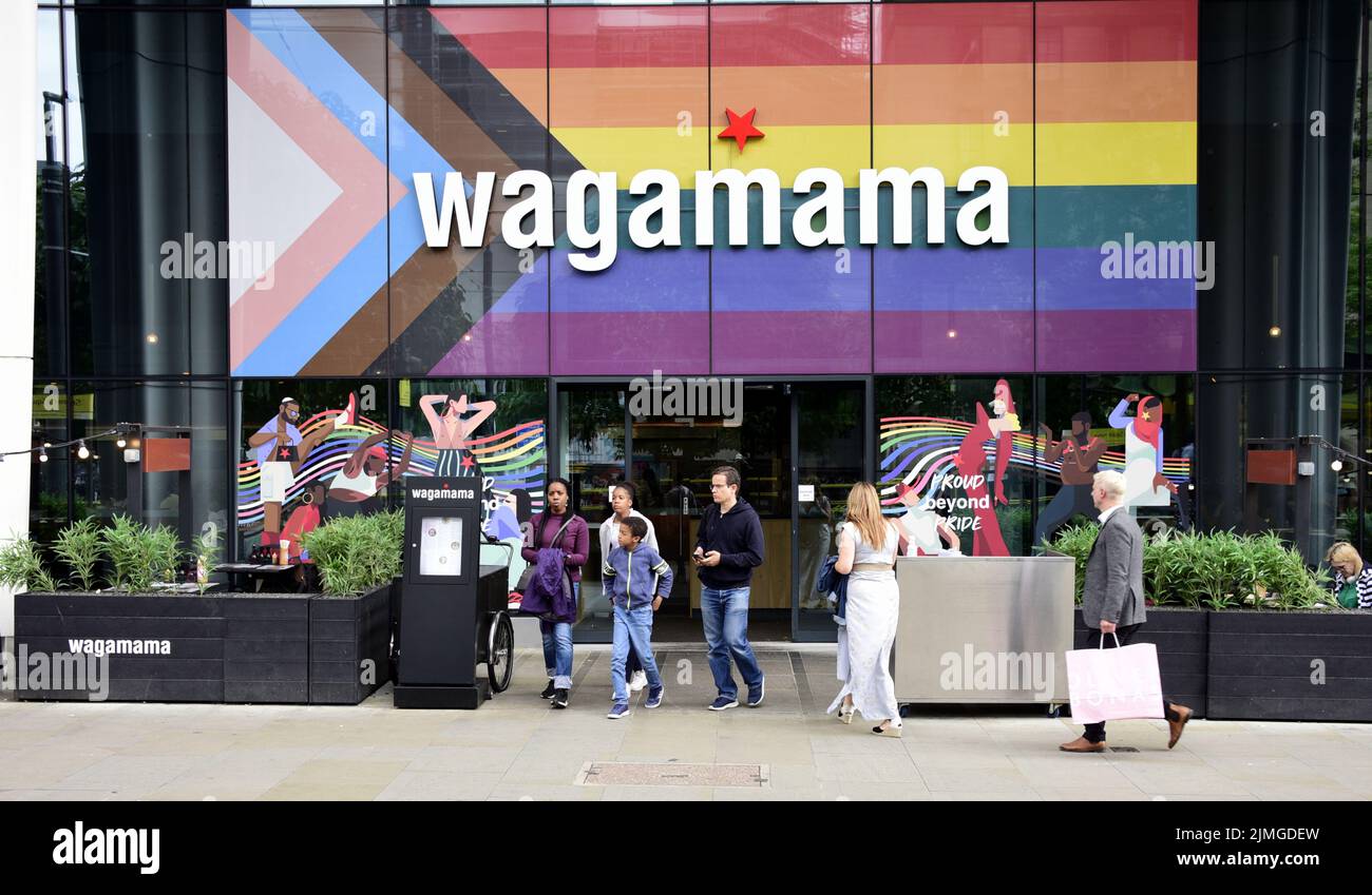 People walk past Wagamama restaurant, St Peter's Square, Manchester, UK ...