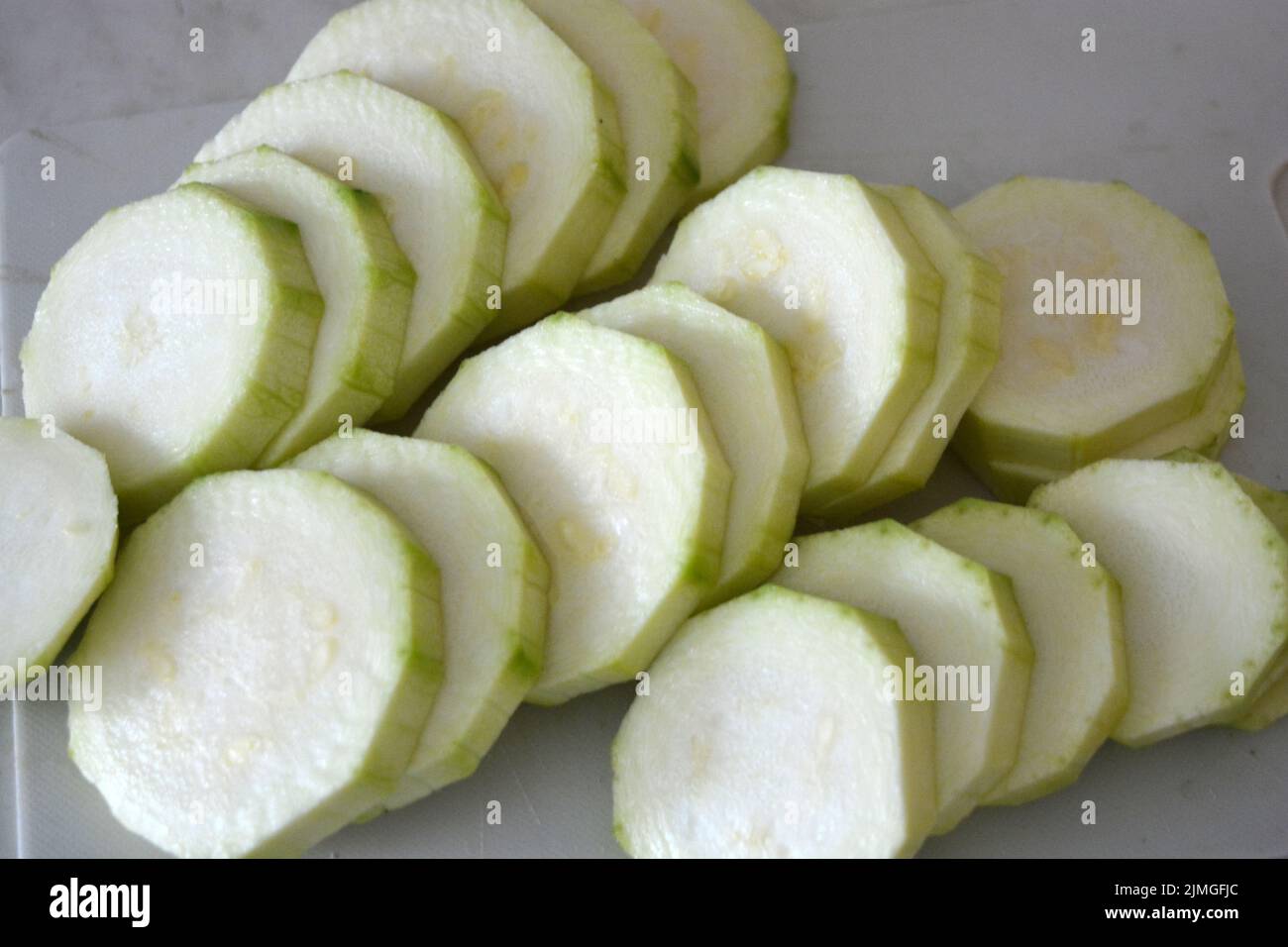 Healthy food, vegetables, peeled zucchini cut into rings and cubes are ...