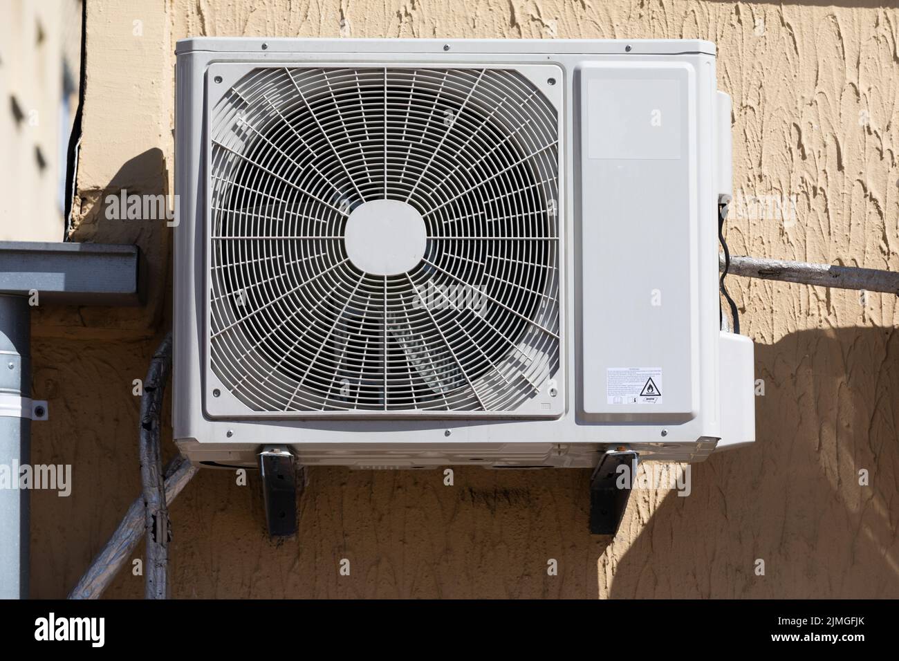 outdoor unit of a domestic air conditioner with a fan outside the ...