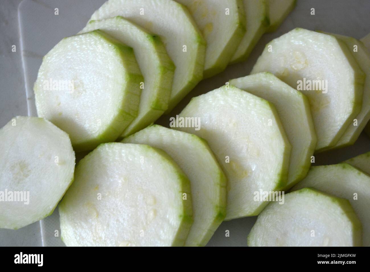 Healthy food, vegetables, peeled zucchini cut into rings and cubes are ...