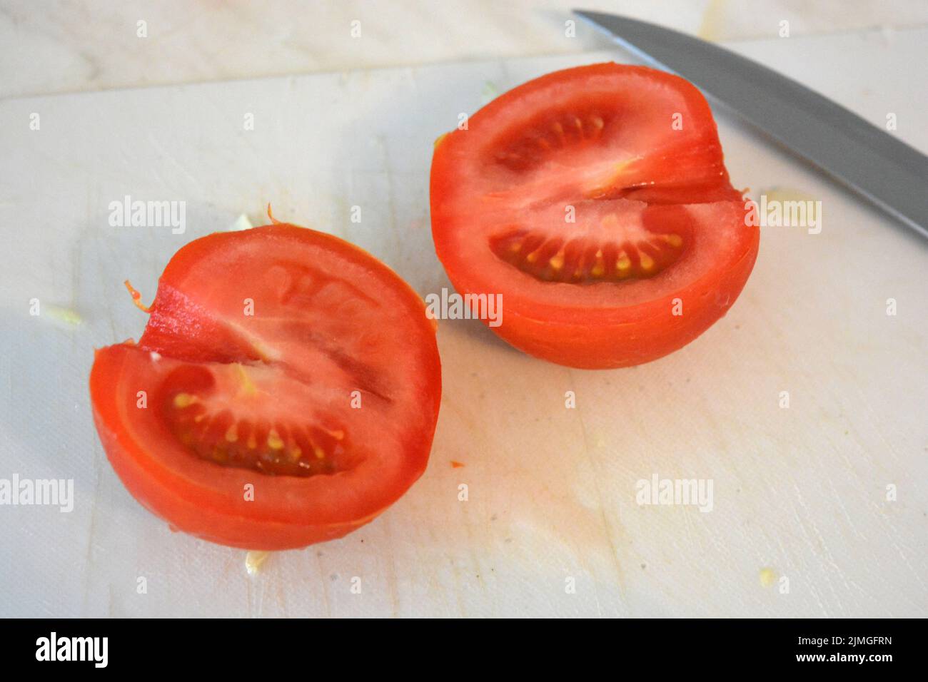 Healthy food, vegetables, large red tomatoes cut into slices or covered ...