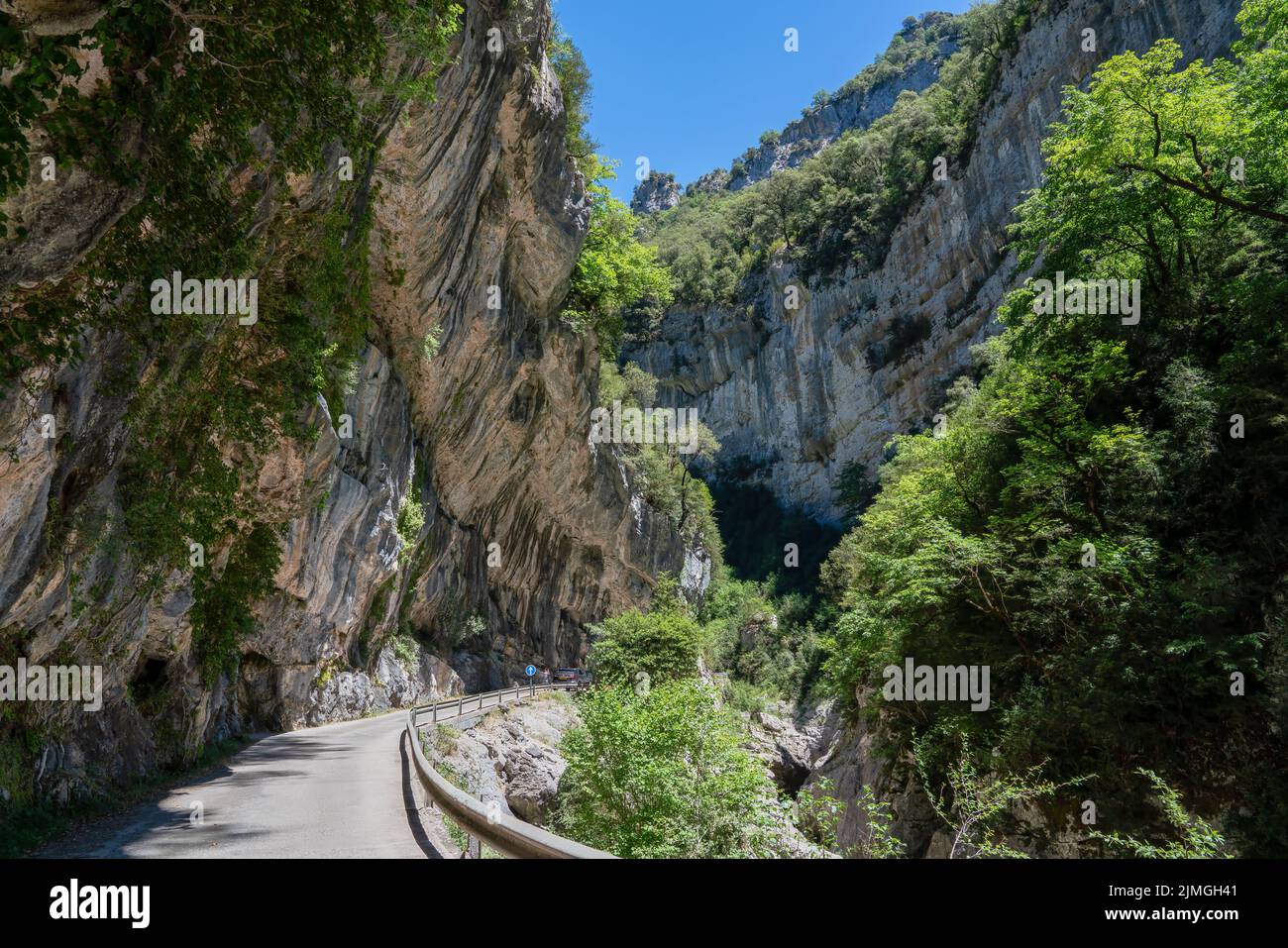 a narrow road winding through a gorge in a mountain range, the Anisclo ...