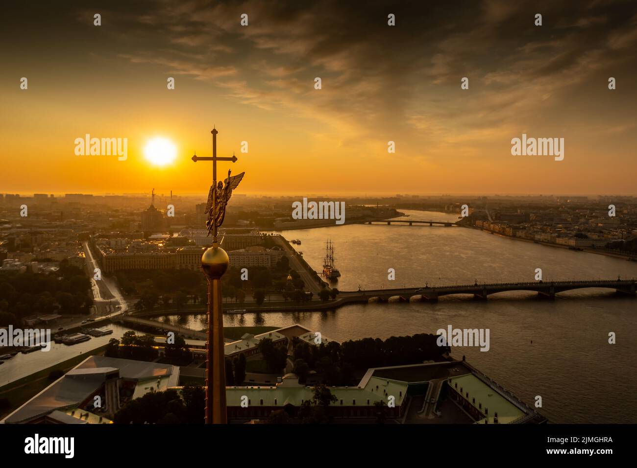 The golden angel on the cross of the Peter and Paul Fortress at sunrise ...