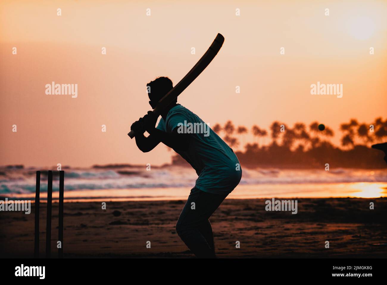 Silhouette of boys playing cricket by the sea Stock Photo - Alamy