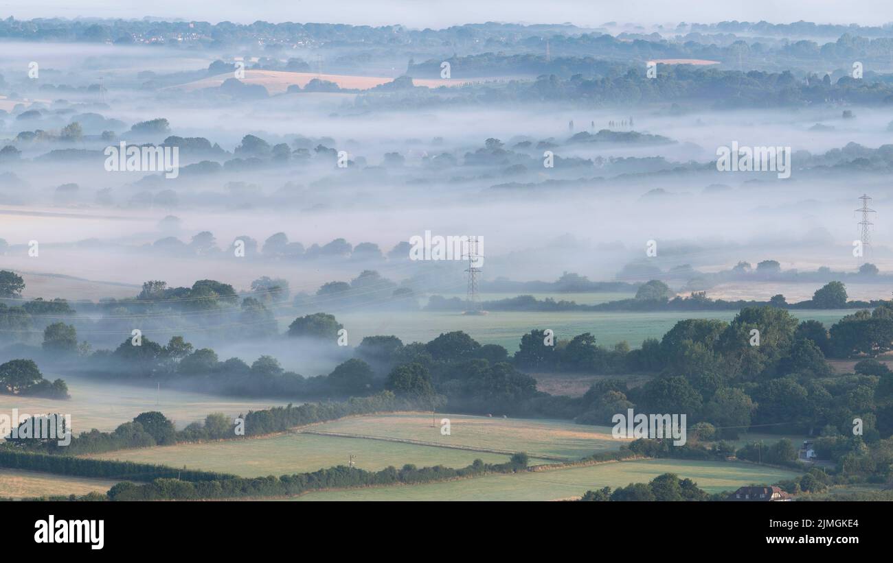 Stunning landscape image of layers of mist rolling over South Downs ...