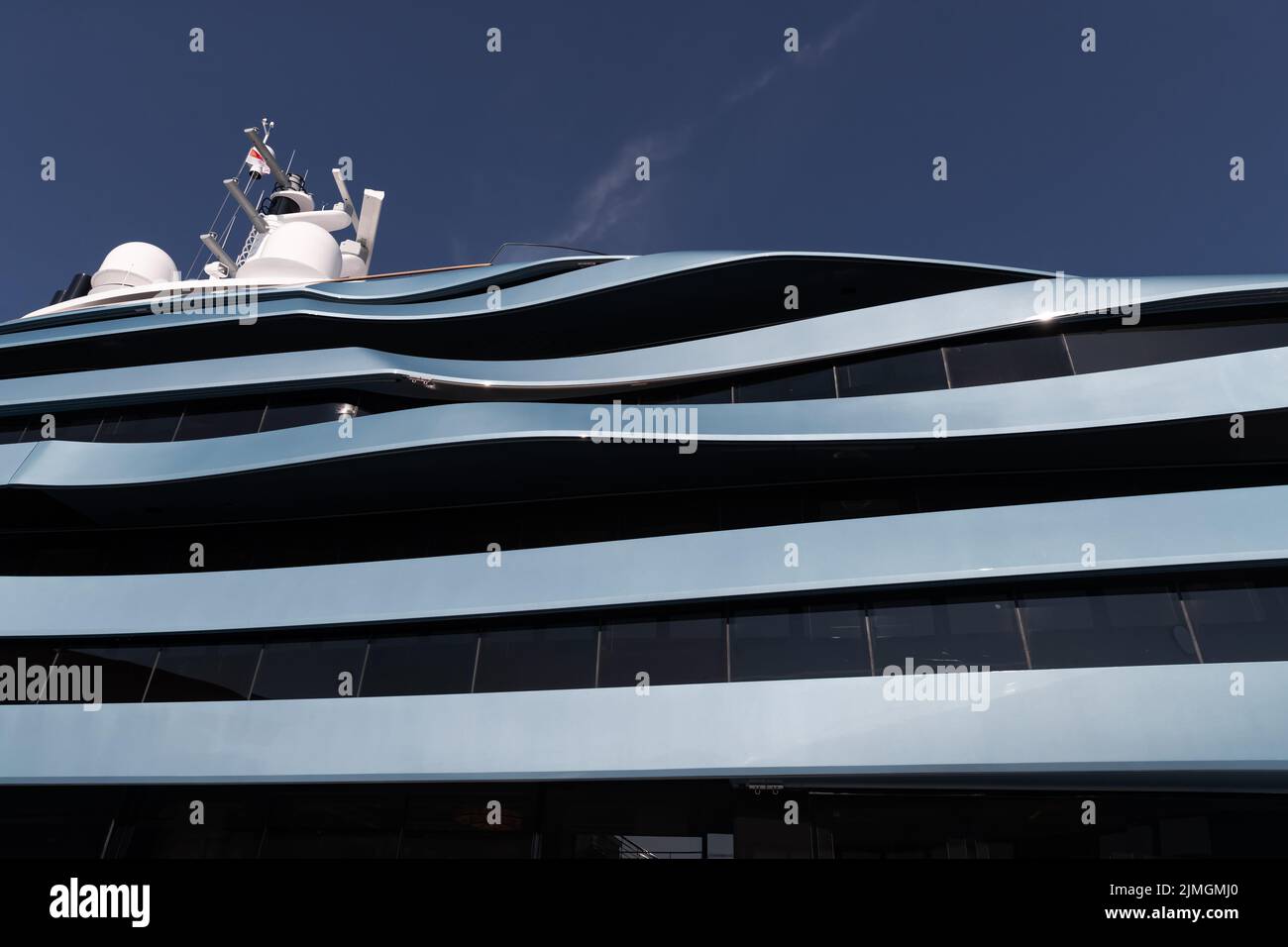 Bottom view of decks of huge yacht of blue color at sunny day, glossy ...