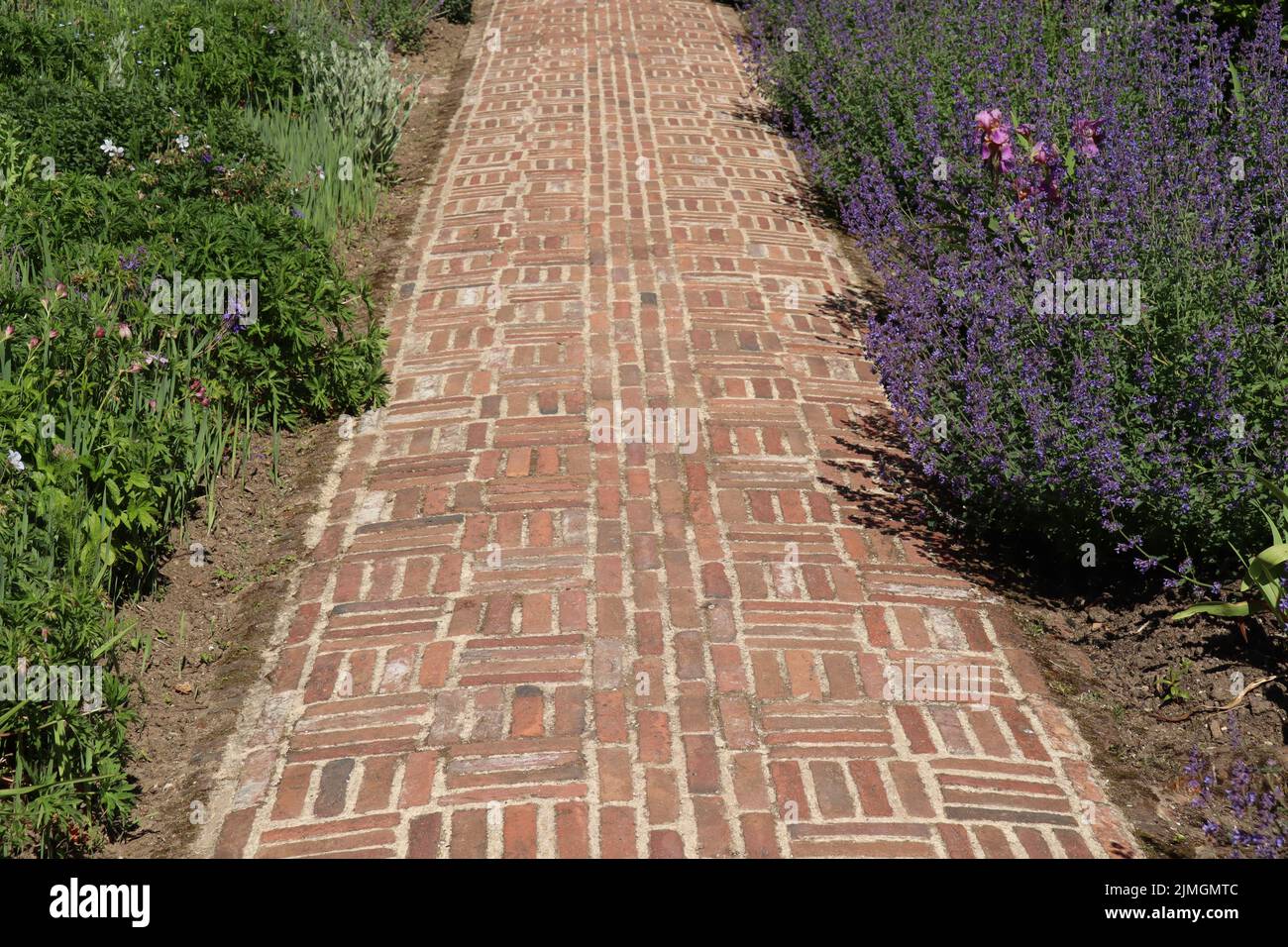 A patterned path formed out of old bricks in the stable area of an old ...