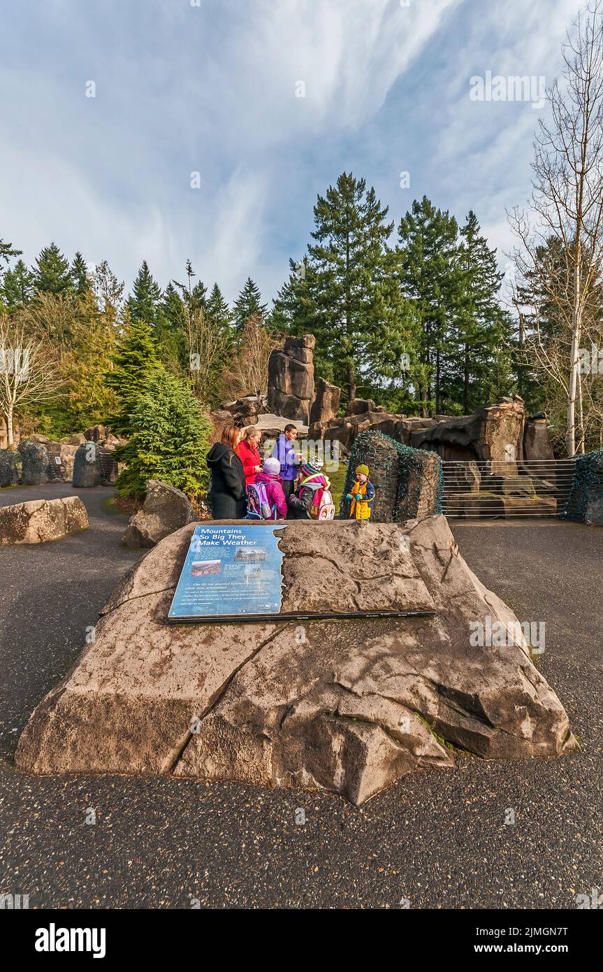 Family near marquee sign showing "Mountains So Big They Make Weather ...