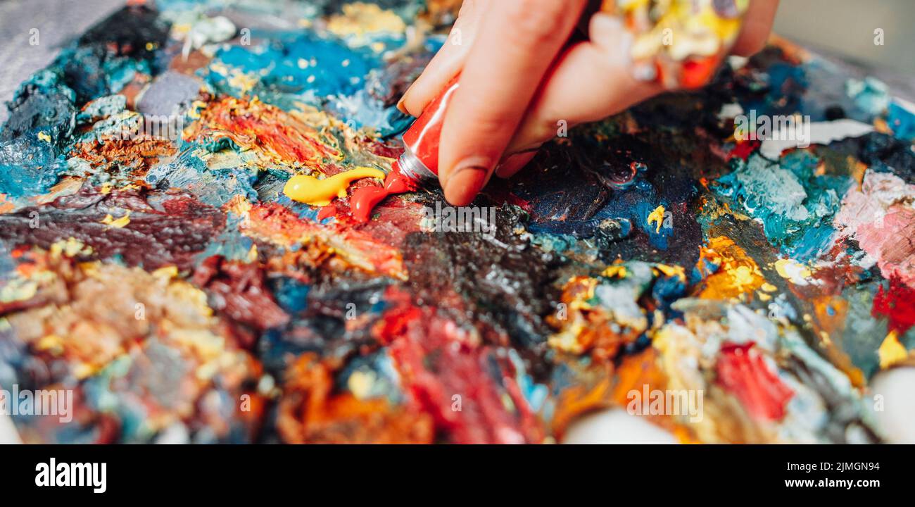 colorful palette lefthanded artist mixing paint Stock Photo - Alamy