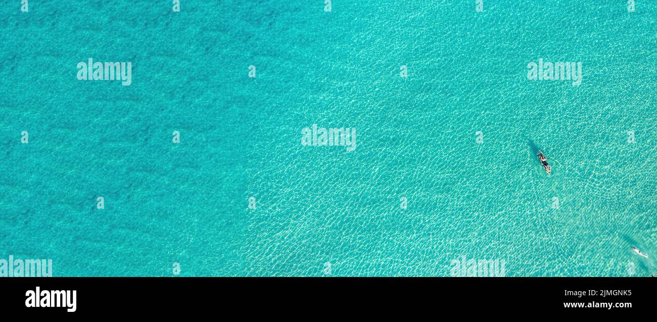 Summer vacation fun, swim and canoe kayak in infinite clear turquoise ...