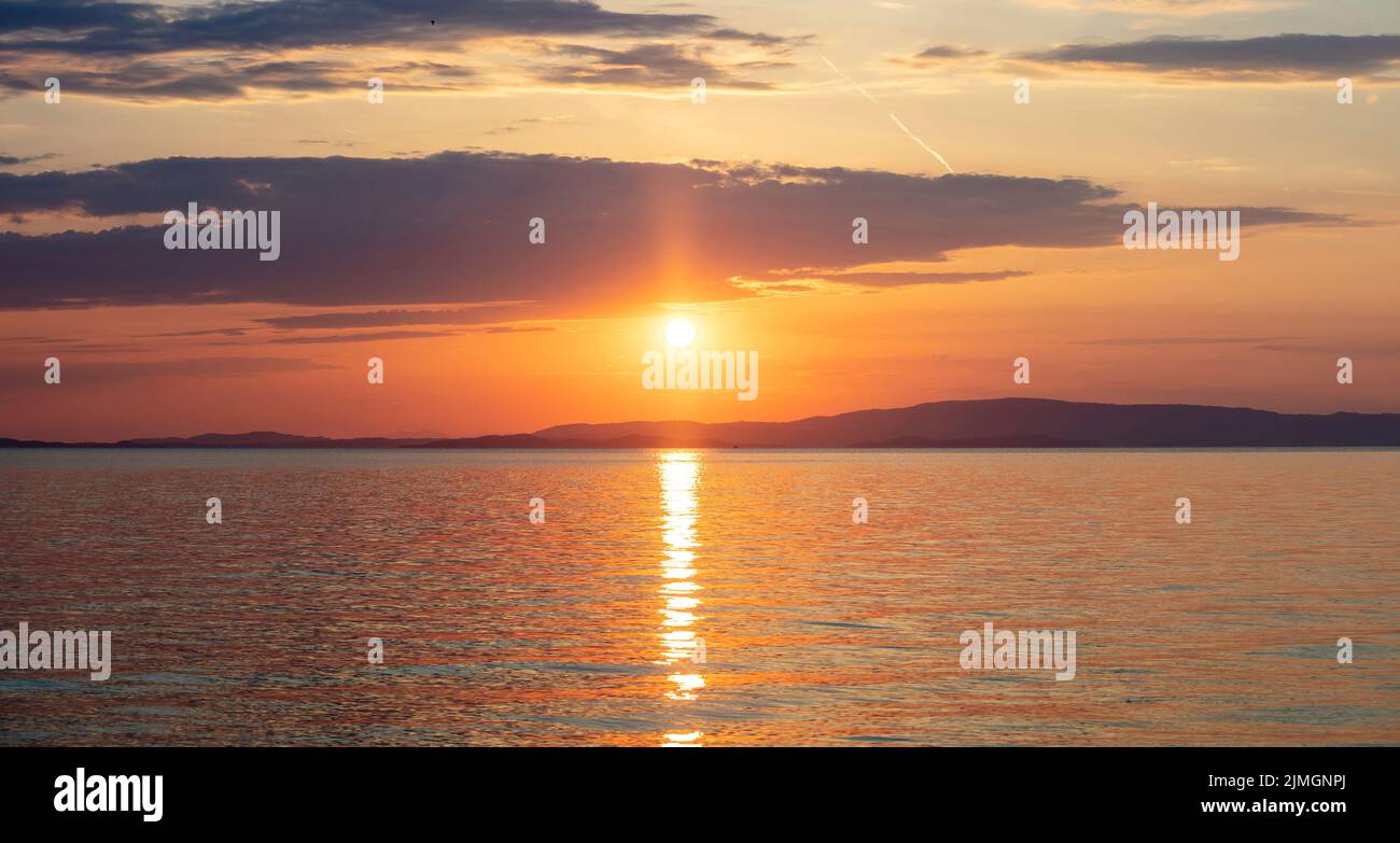 Sunset over Aegean Sea. Greece. Sun falling behind dark land, golden ...