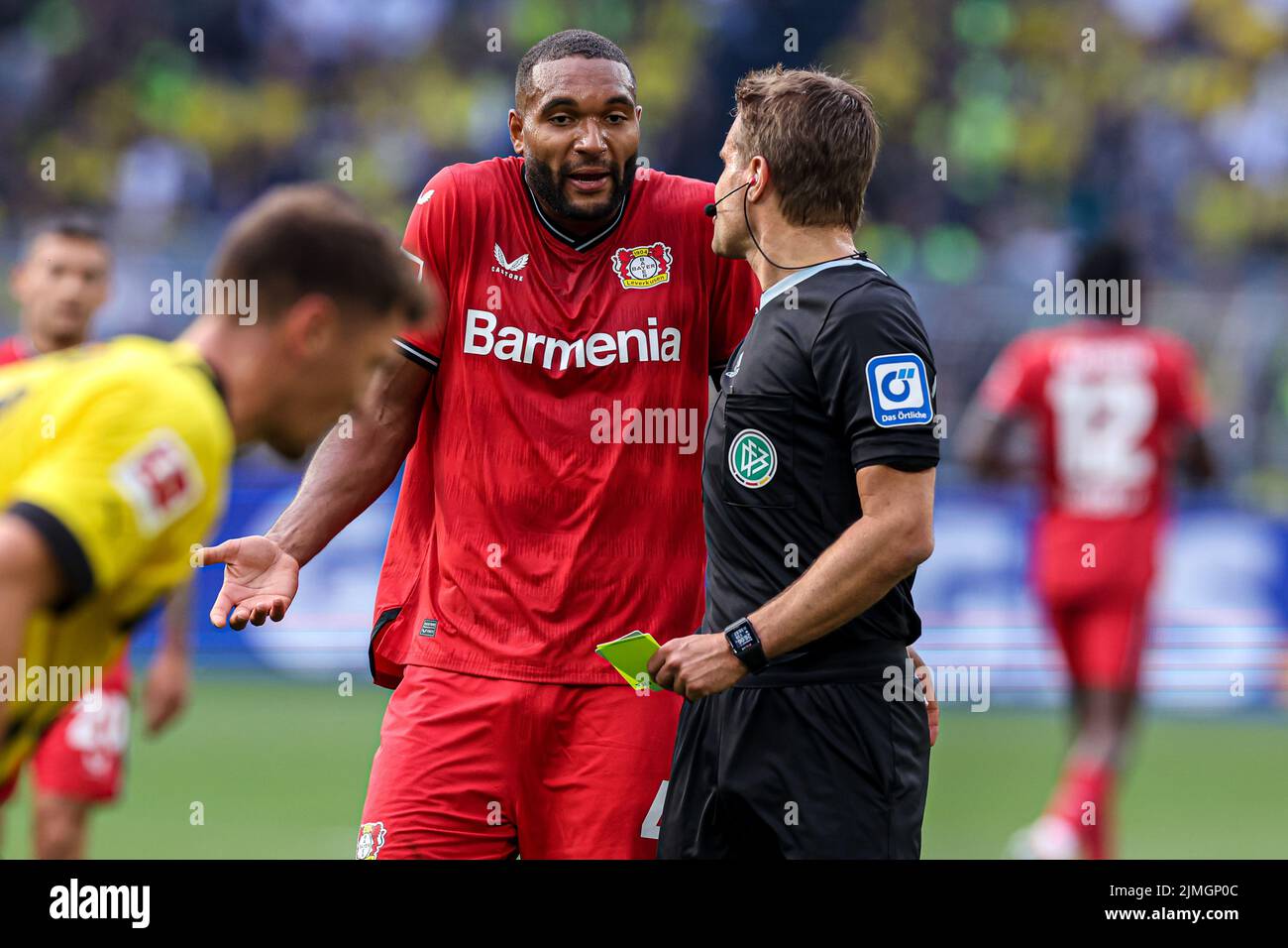 DORTMUND, GERMANY - AUGUST 6: Jonathan Tah of Bayer Leverkusen receives ...